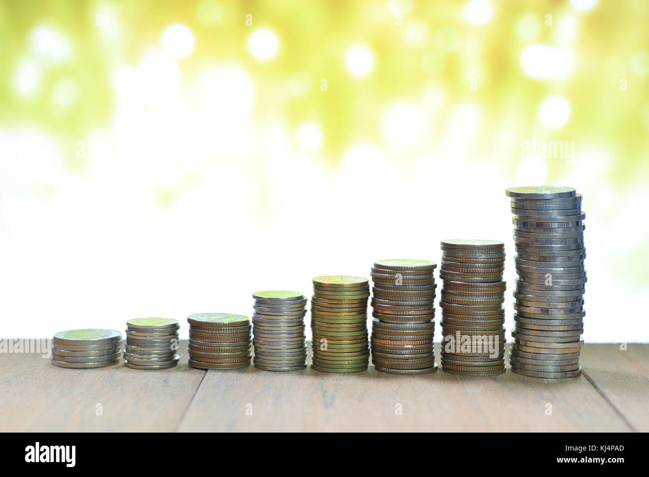Coin stack with blur light dreamy bokeh background. Business, finance and saving concept Stock ...