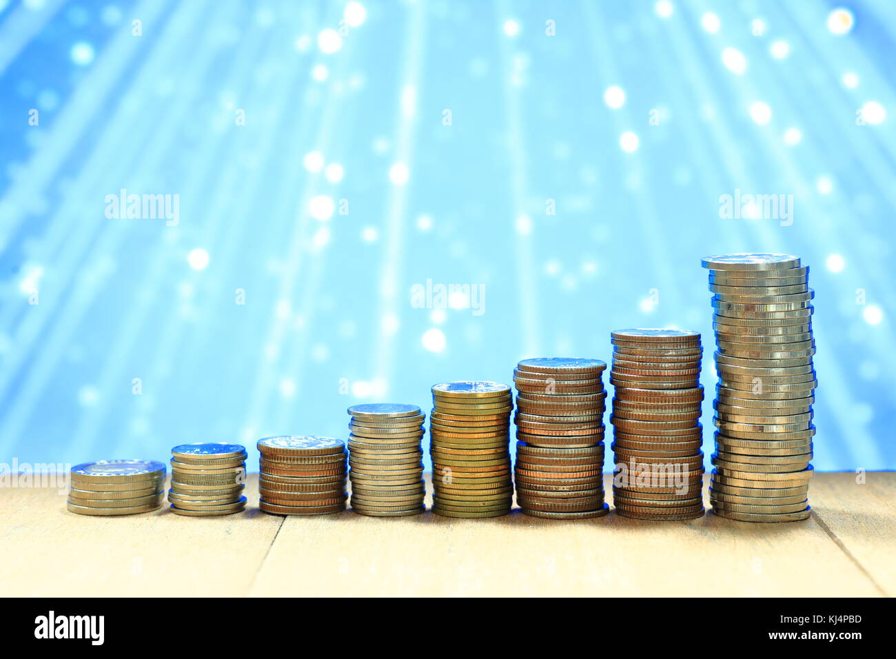 Coin stack with blur light dreamy bokeh background. Business, finance ...