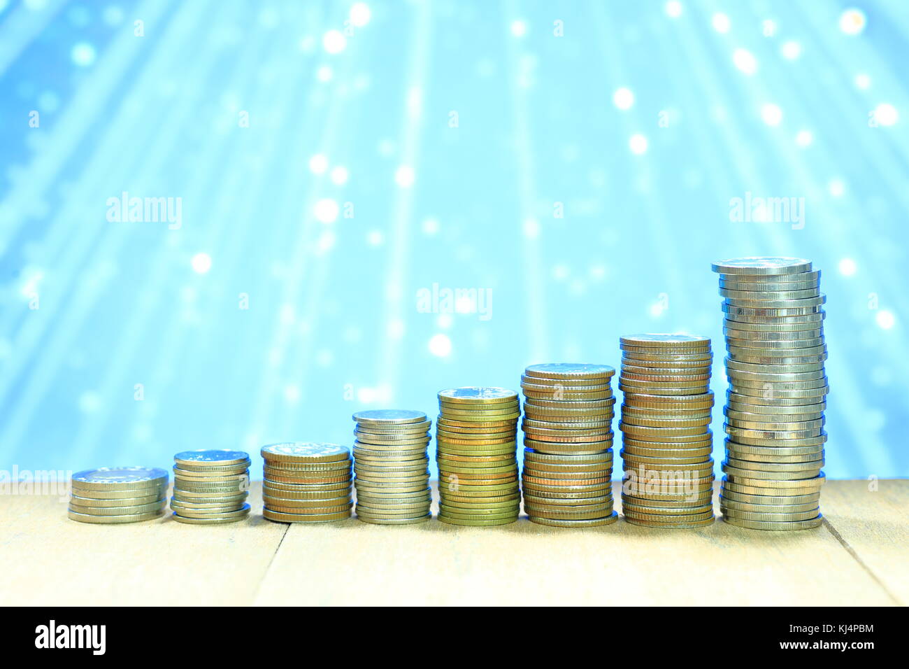 Coin stack with blur light dreamy bokeh background. Business, finance and saving concept Stock ...