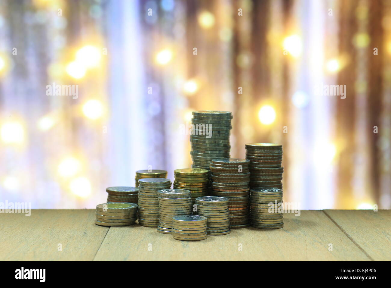Coin stack with blur light dreamy bokeh background. Business, finance and saving concept Stock ...