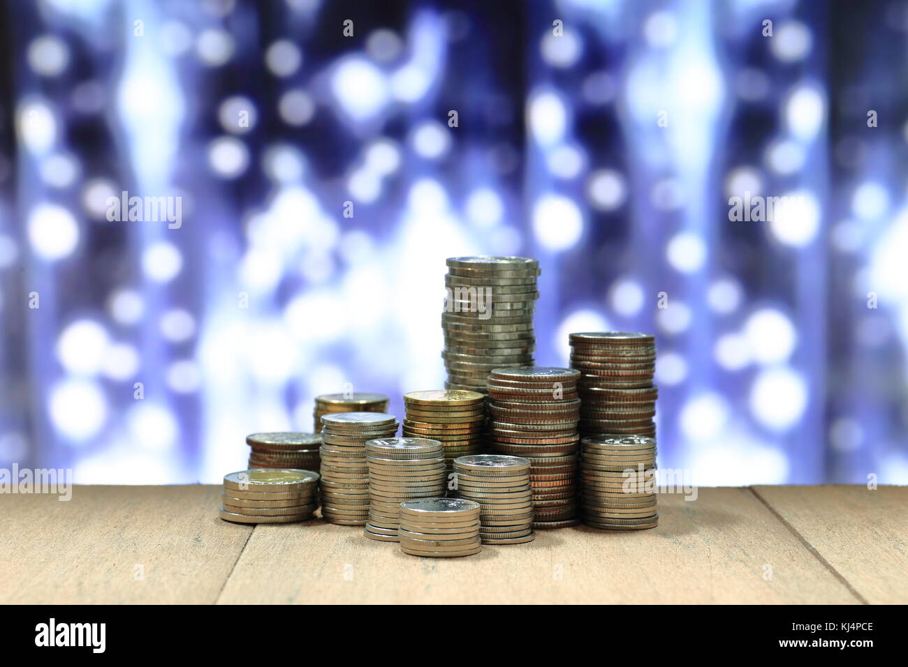 Coin stack with blur light dreamy bokeh background. Business, finance and saving concept Stock ...