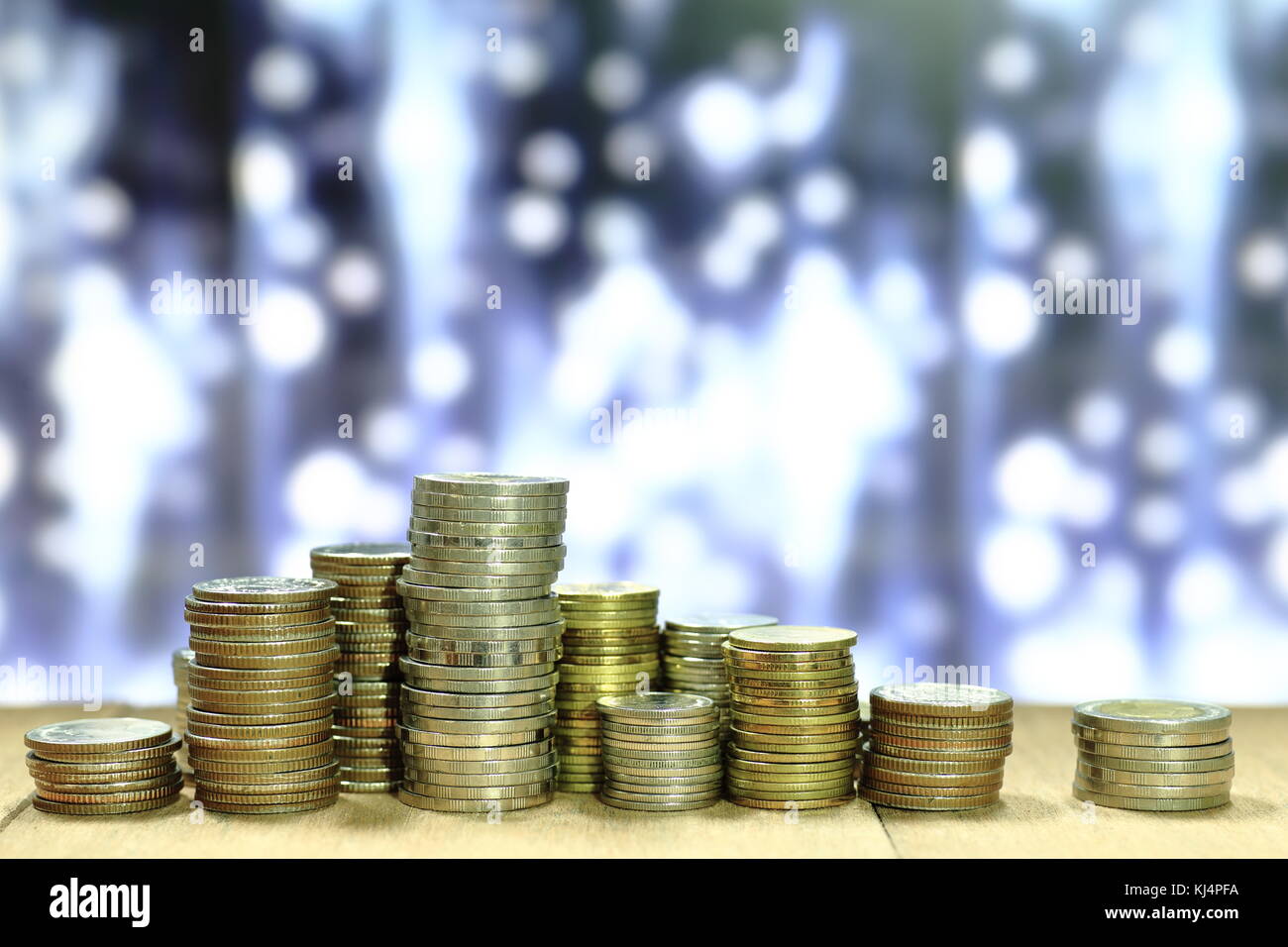 Coin stack with blur light dreamy bokeh background. Business, finance and saving concept Stock ...