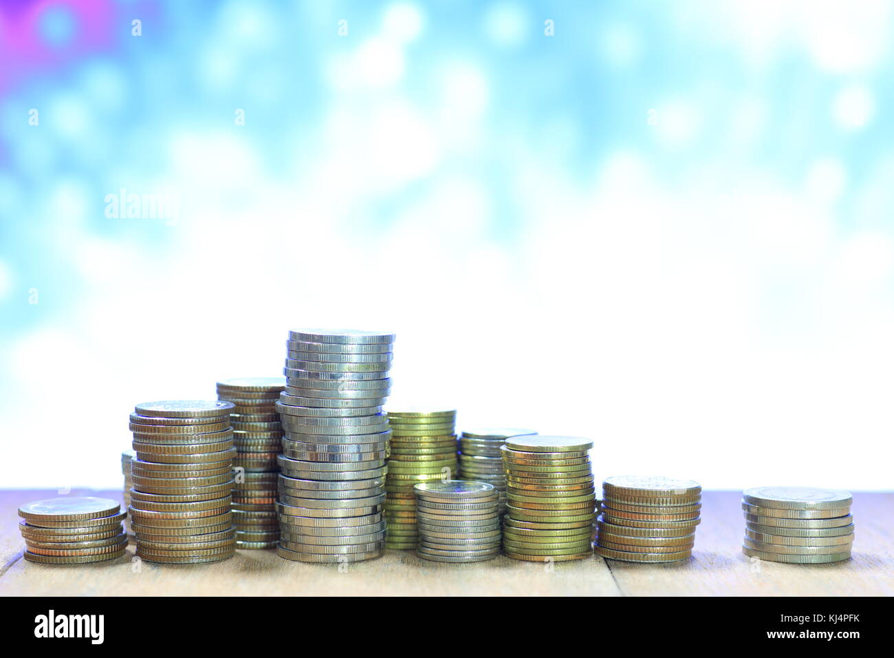 Coin stack with blur light dreamy bokeh background. Business, finance and saving concept Stock ...