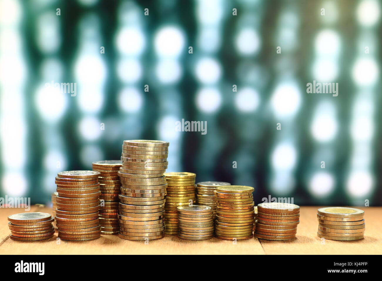 Coin stack with blur light dreamy bokeh background. Business, finance ...