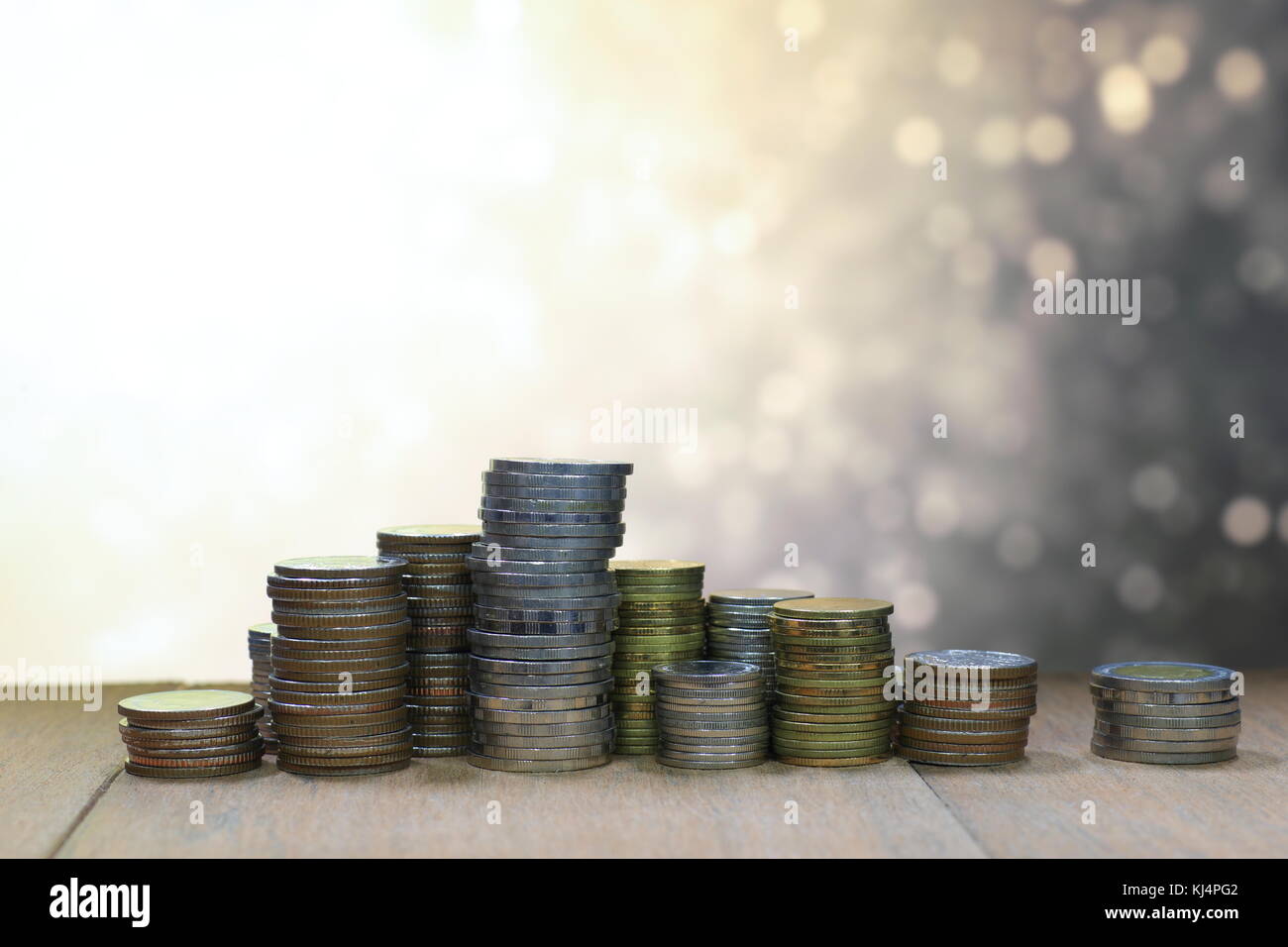Coin stack with blur light dreamy bokeh background. Business, finance ...