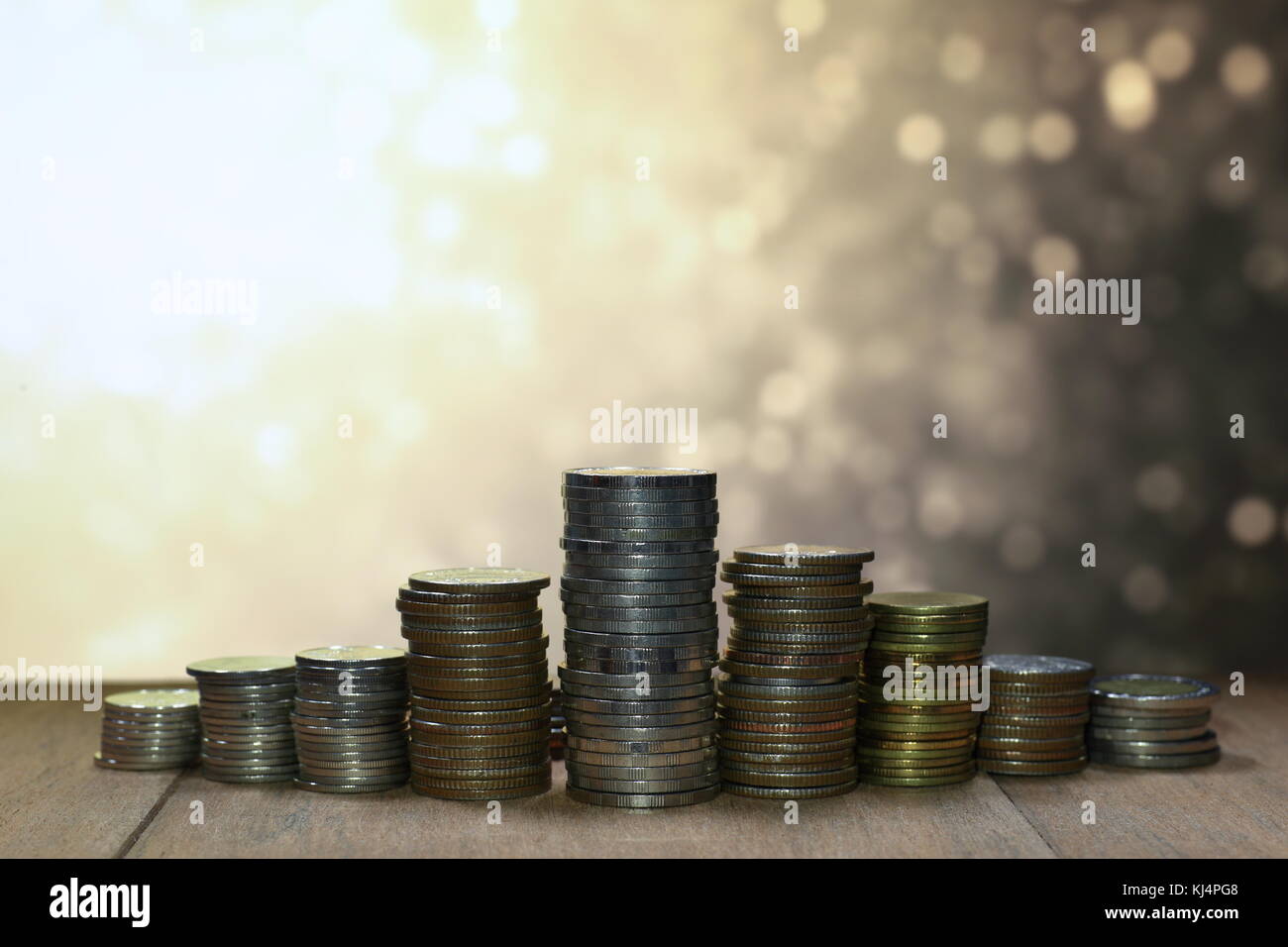 Coin stack with blur light dreamy bokeh background. Business, finance ...