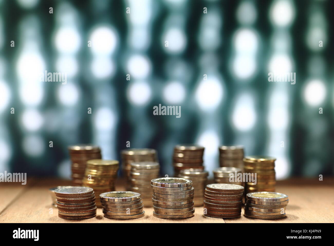 Coin stack with blur light dreamy bokeh background. Business, finance ...