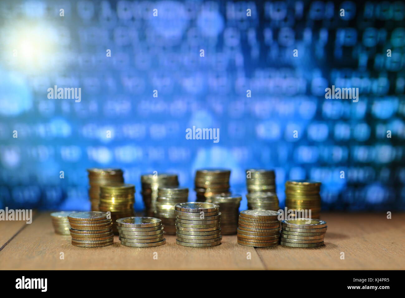 Digital economy. Coin stack with blue binary digital numbers background ...