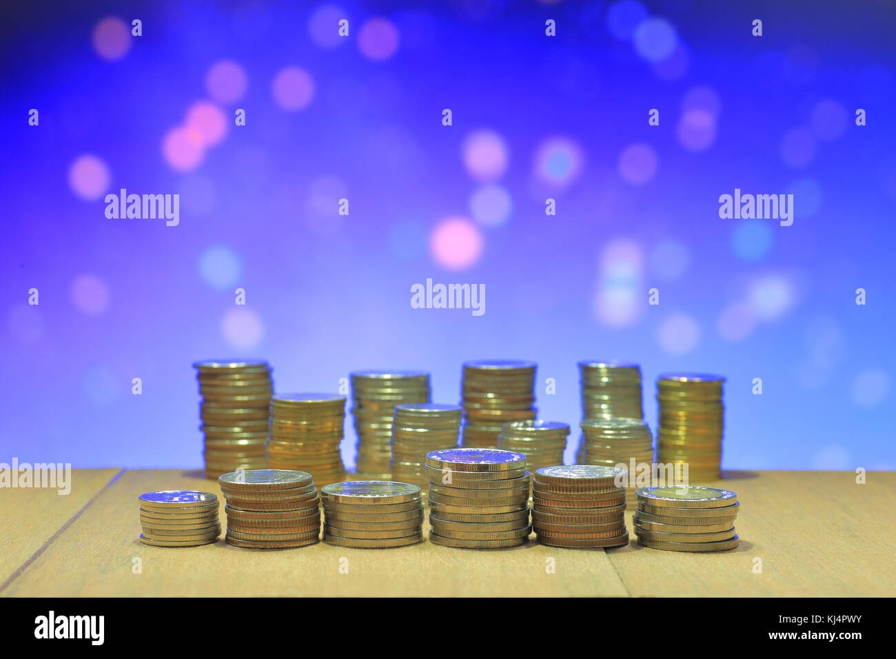Coin stack with blur light dreamy bokeh background. Business, finance and saving concept Stock ...