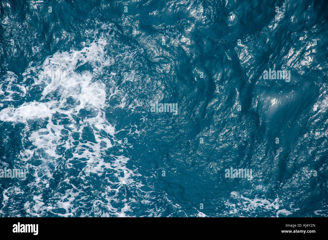 Blue sea texture with waves and foam Stock Photo - Alamy
