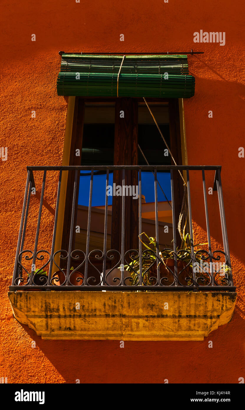 Stylish balcony with a metal railing, solid architectural element, a ...