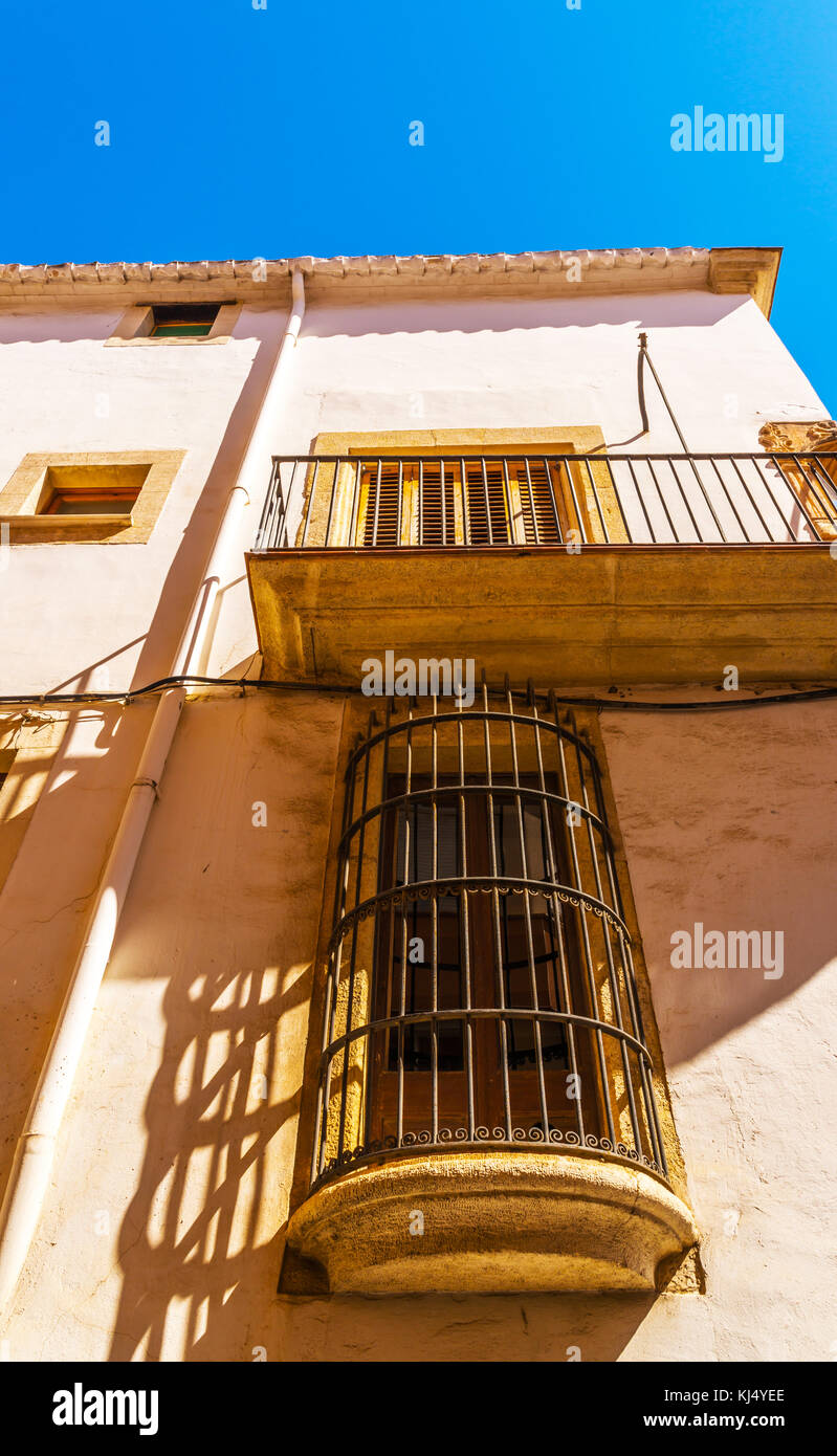 Stylish balcony with a metal railing, solid architectural element, a ...