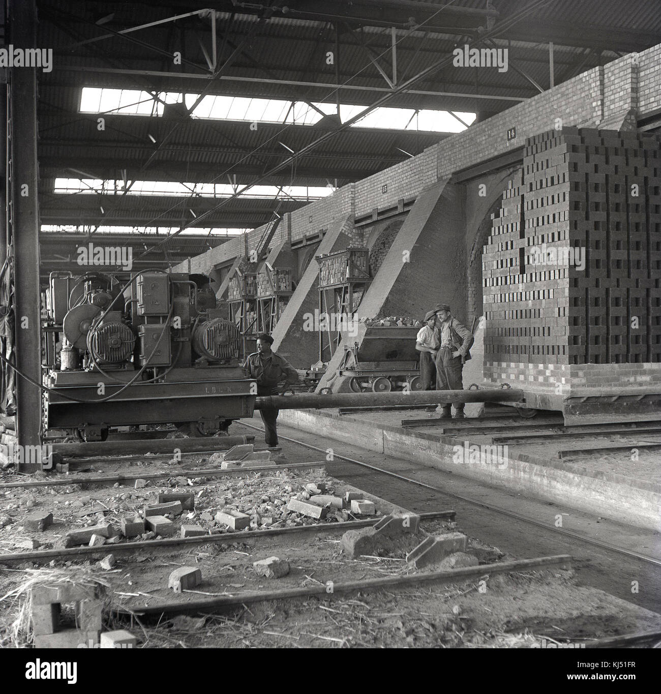 1950s, workers inside one of the giant kilns wher the bricks are fired ...