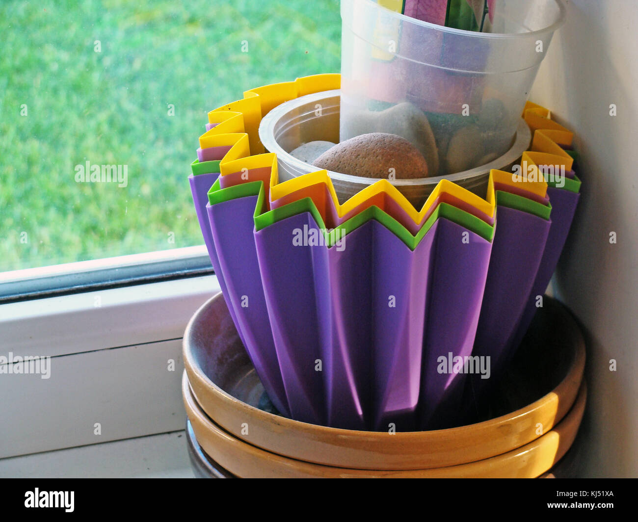 Colorful plastic and ceramic flower pots on window sill close up Stock ...