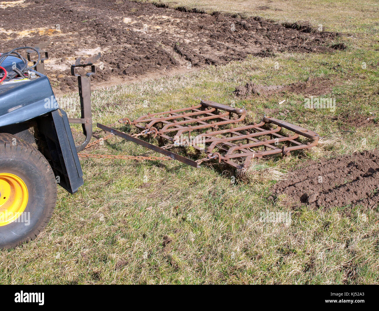 Lawn aeration harrowing by tractor powered light harrows Stock Photo ...
