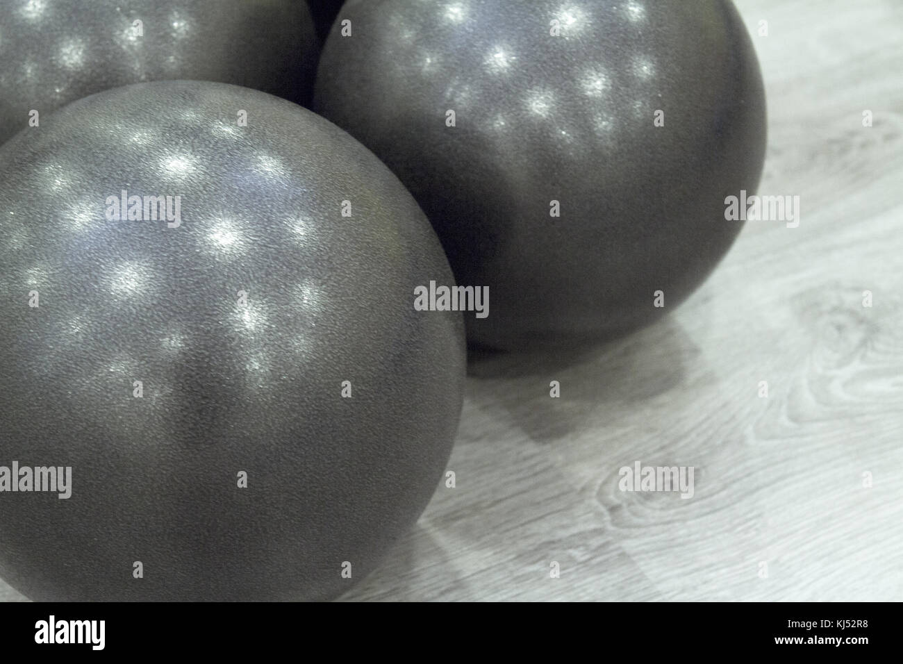 Medium size black balls for pilates exercises Stock Photo - Alamy