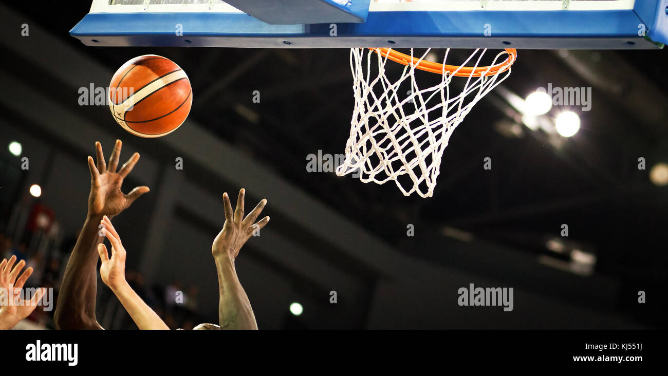 scoring during a basketball game - ball in hoop Stock Photo - Alamy