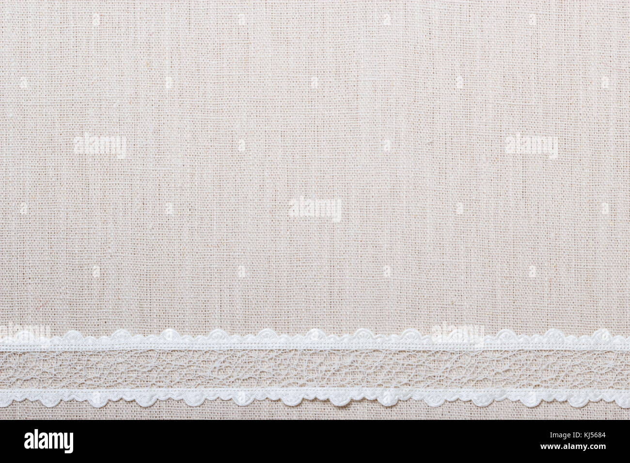 Lace ribbon on natural linen, bright cloth fabric background. Border ...