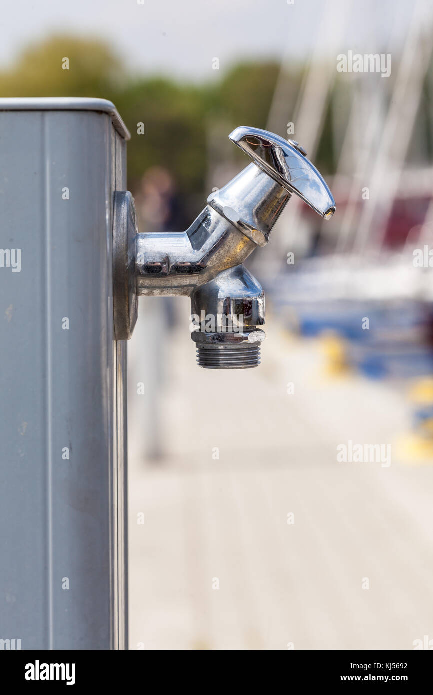 Hydration during walking concept. Small metal tap water outside for use ...