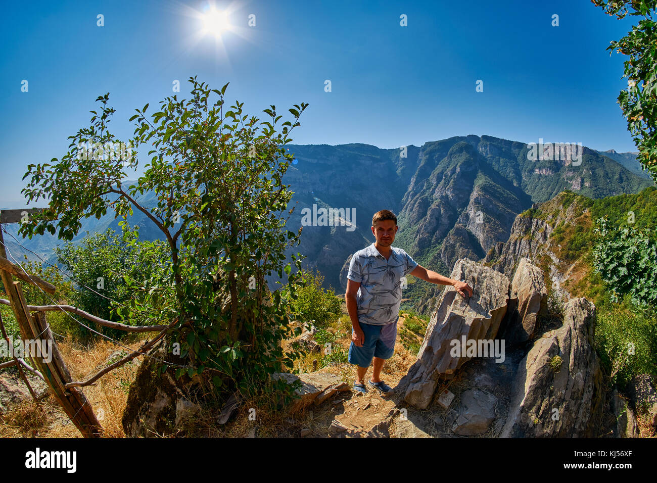 Young Man at the edge of Mountain Gorge near Tatev Monastery in Armenia ...