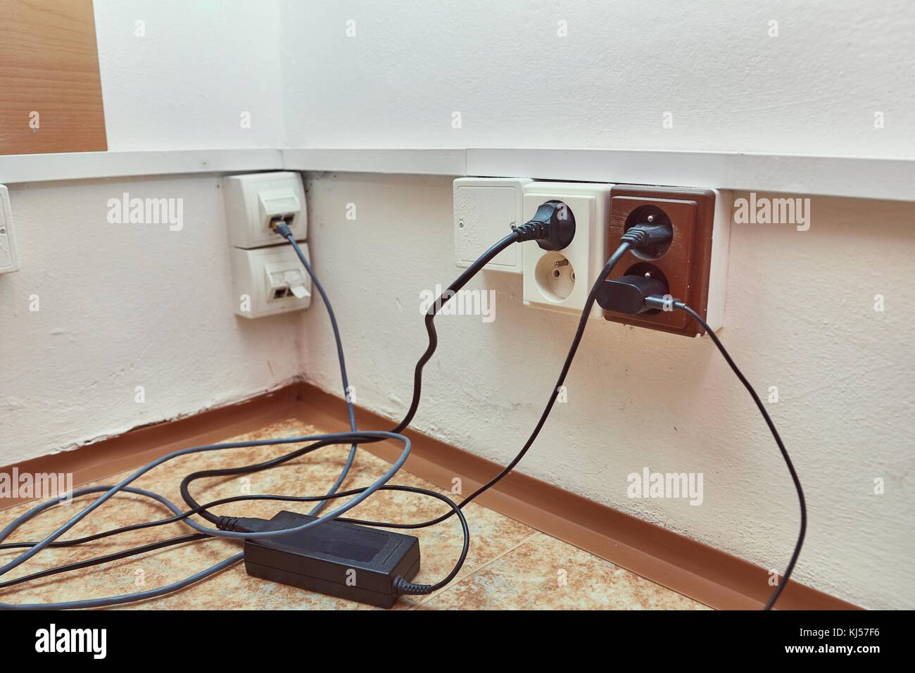 Electric outlets with connected cables Stock Photo - Alamy