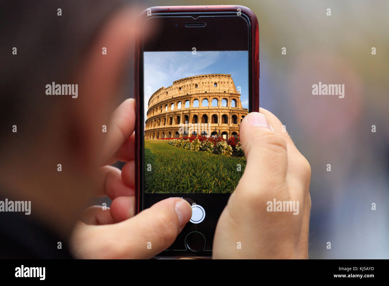 Colosseum in Rome, Italy picture appears on tablet, smartphone in man's ...