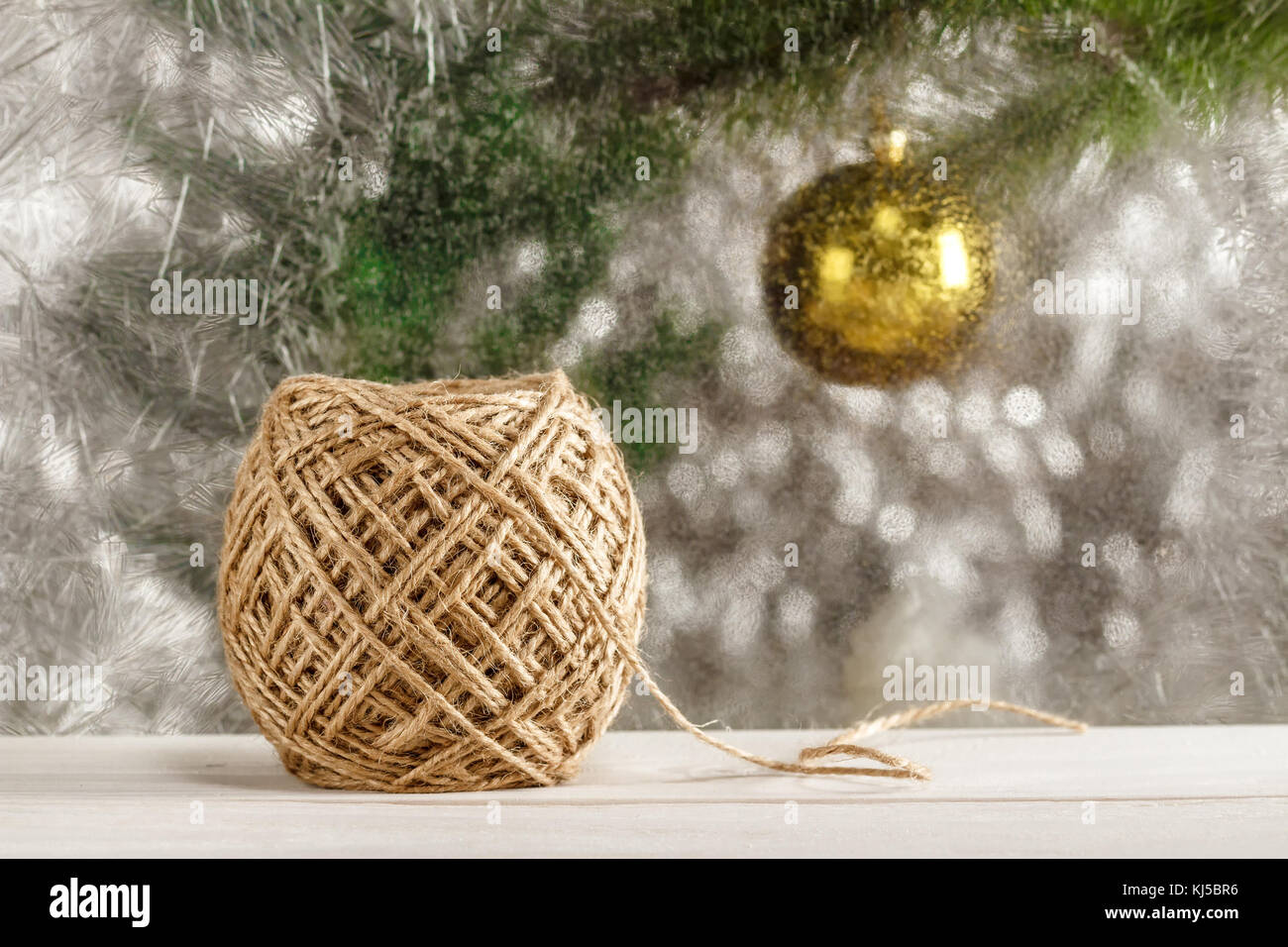 Jute twine for wrapping Christmas gifts. Sill frosty Windows. Blurred ...