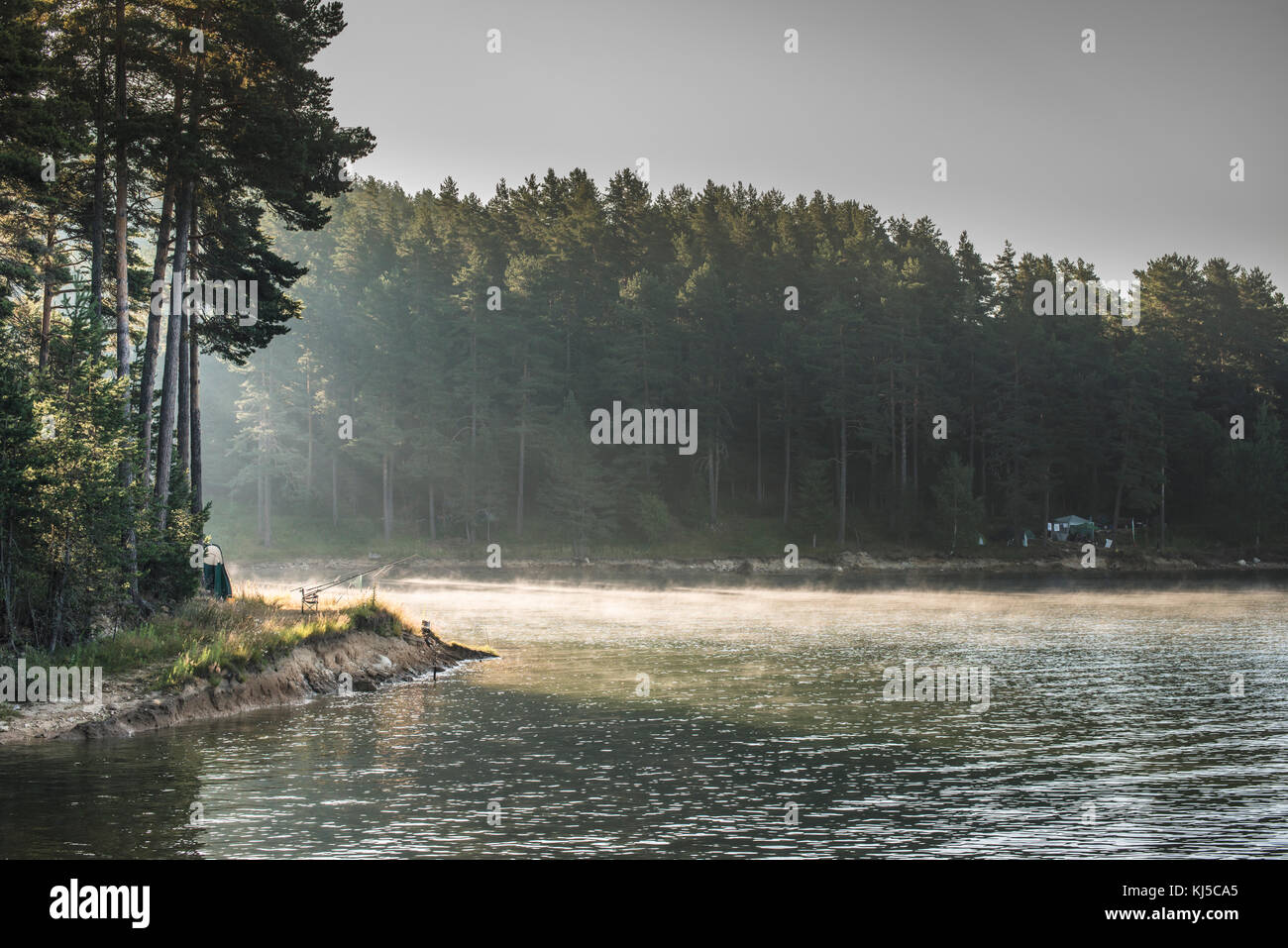 Mountain lake early in the morning. Water vapor Stock Photo - Alamy