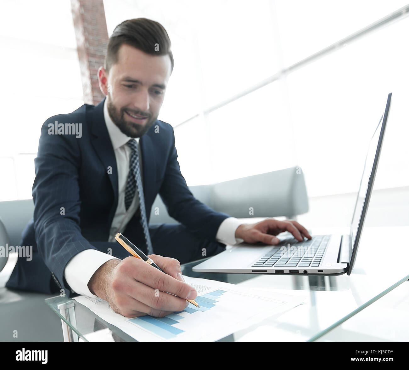 finance manager working with business graphics on a laptop Stock Photo ...