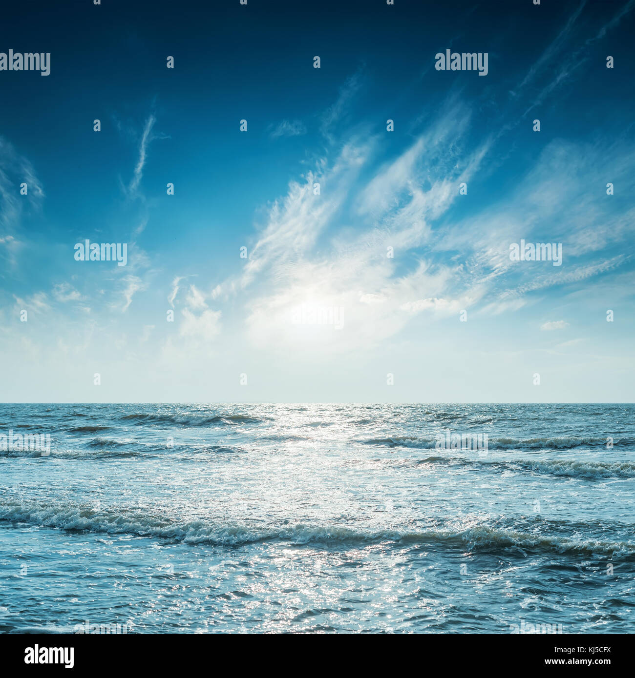 sunset in blue sky over sea Stock Photo - Alamy