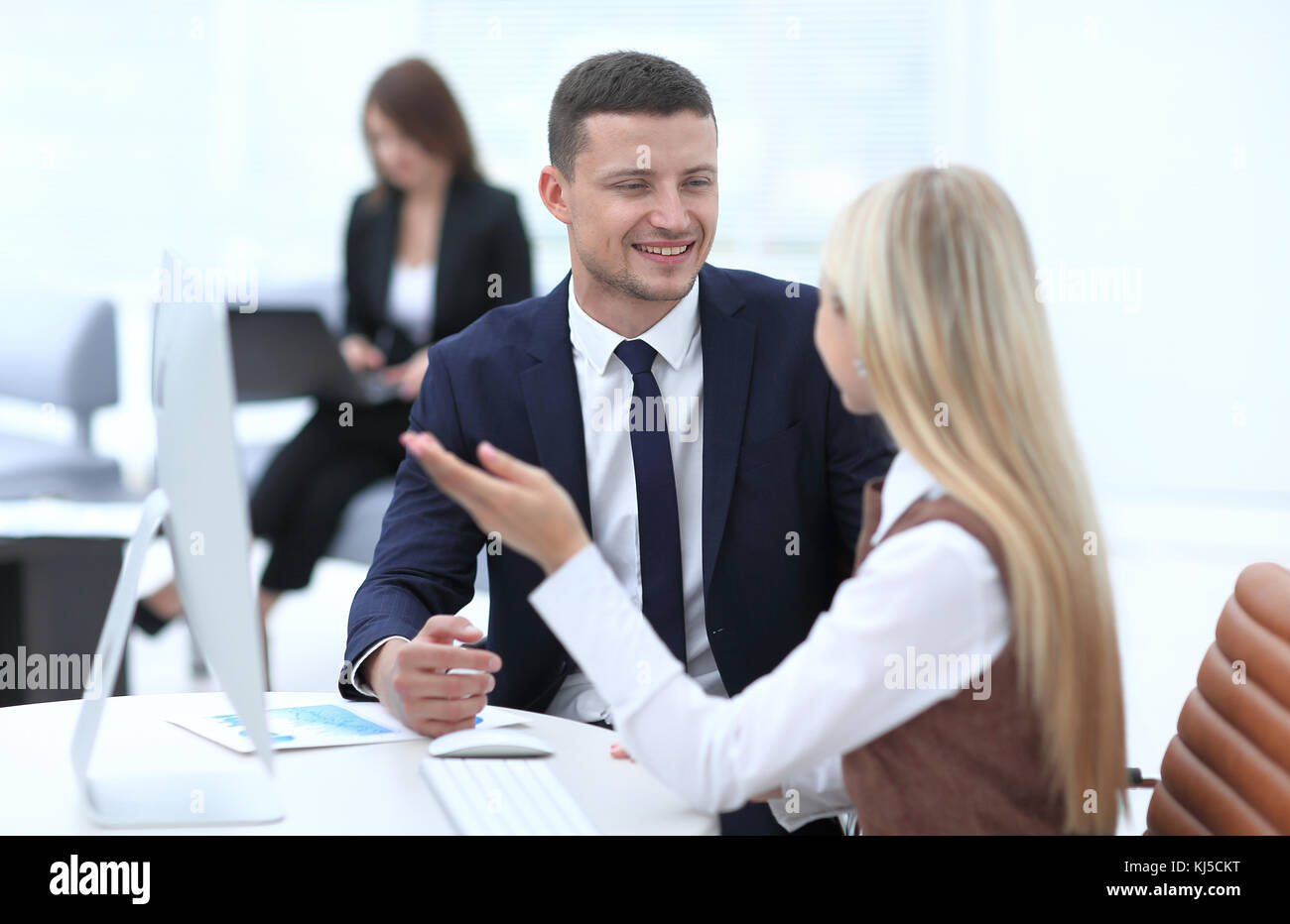 Manager talking with a colleague at the workplace Stock Photo - Alamy