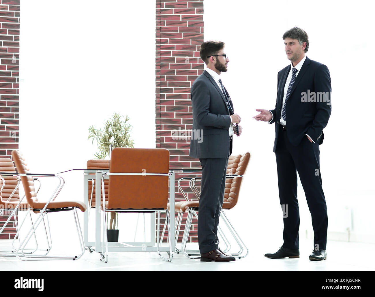 Two business executives talking about business in the office Stock ...