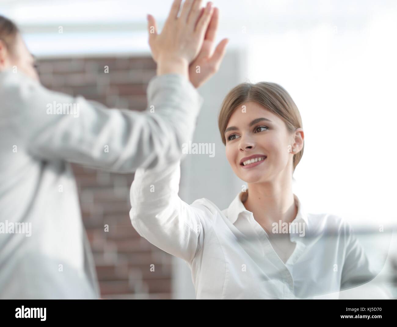 members of the business team giving each other a high five Stock Photo ...