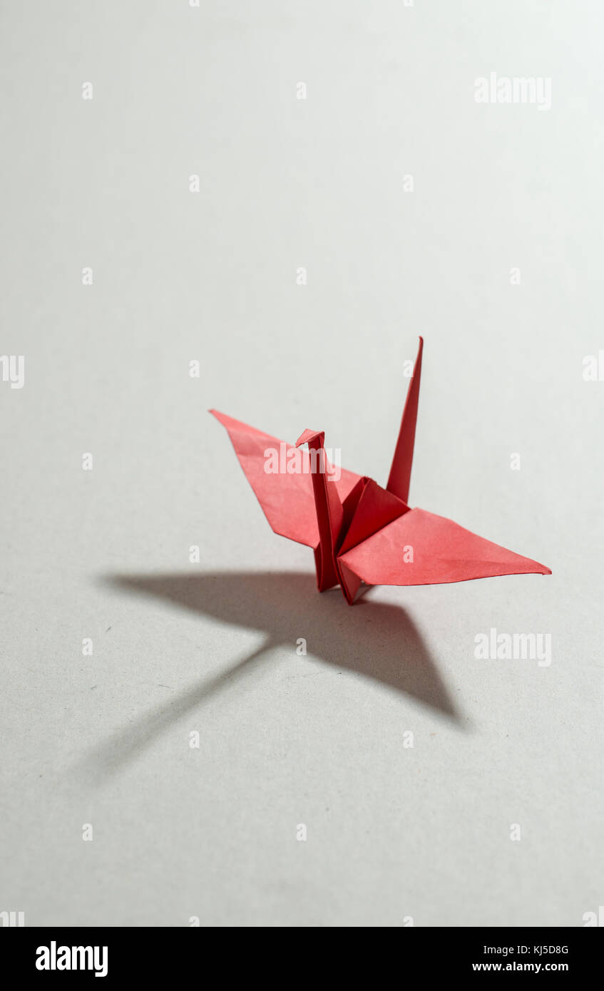 Crane origami on paper background Stock Photo - Alamy