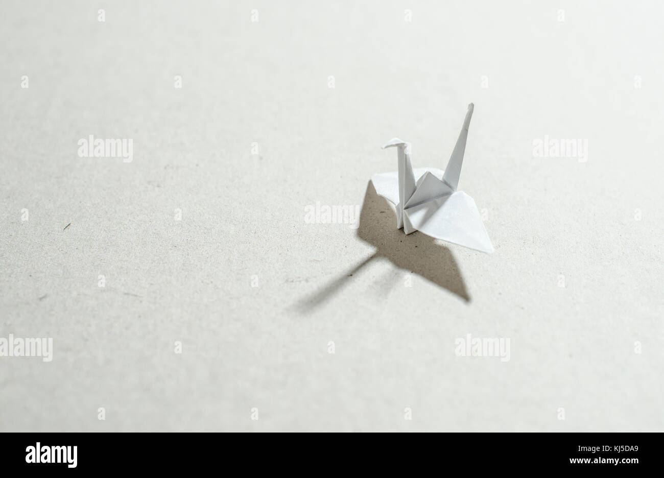 Crane origami on paper background Stock Photo - Alamy