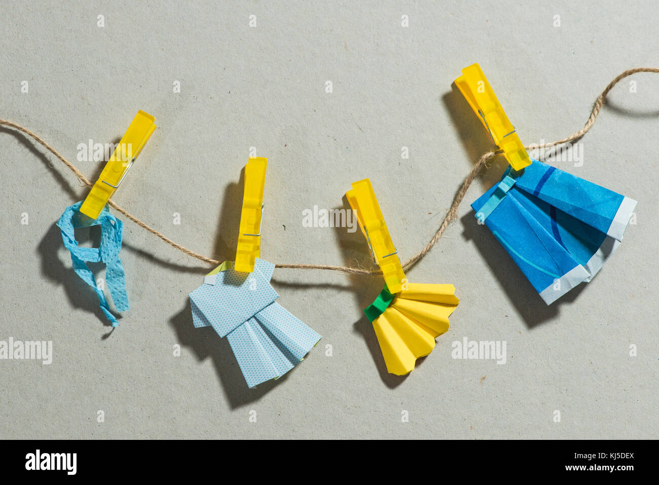 Origami clothes on laundry. Paper background Stock Photo - Alamy