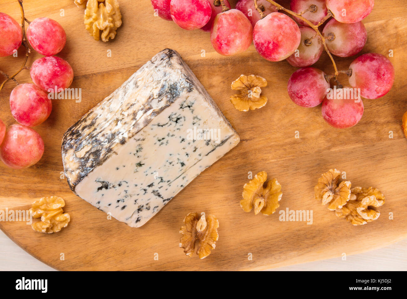 Closeup of blue cheese with grapes, nuts, and toasts Stock Photo - Alamy