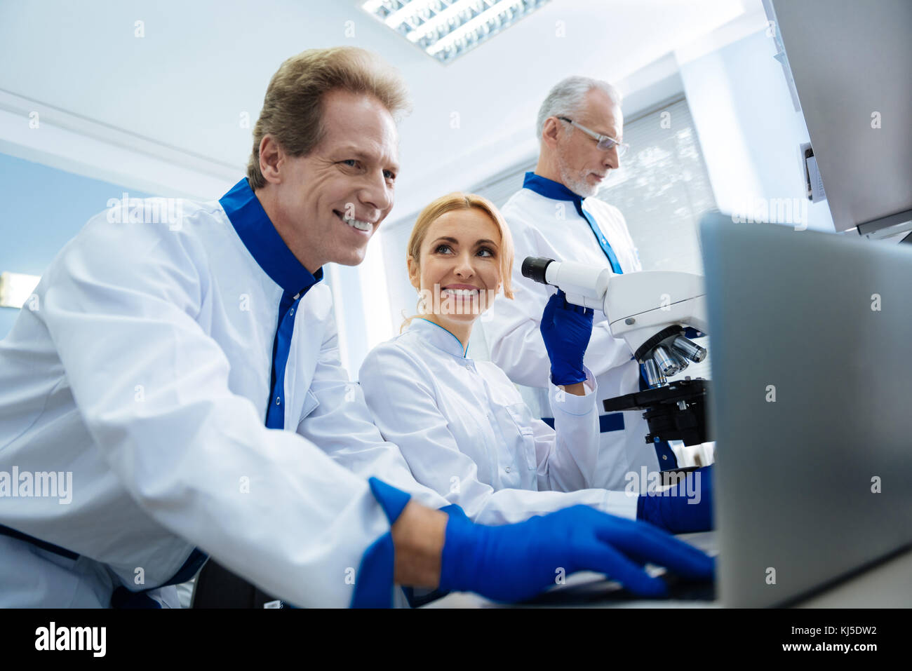 Happy scientists working together in the lab Stock Photo - Alamy