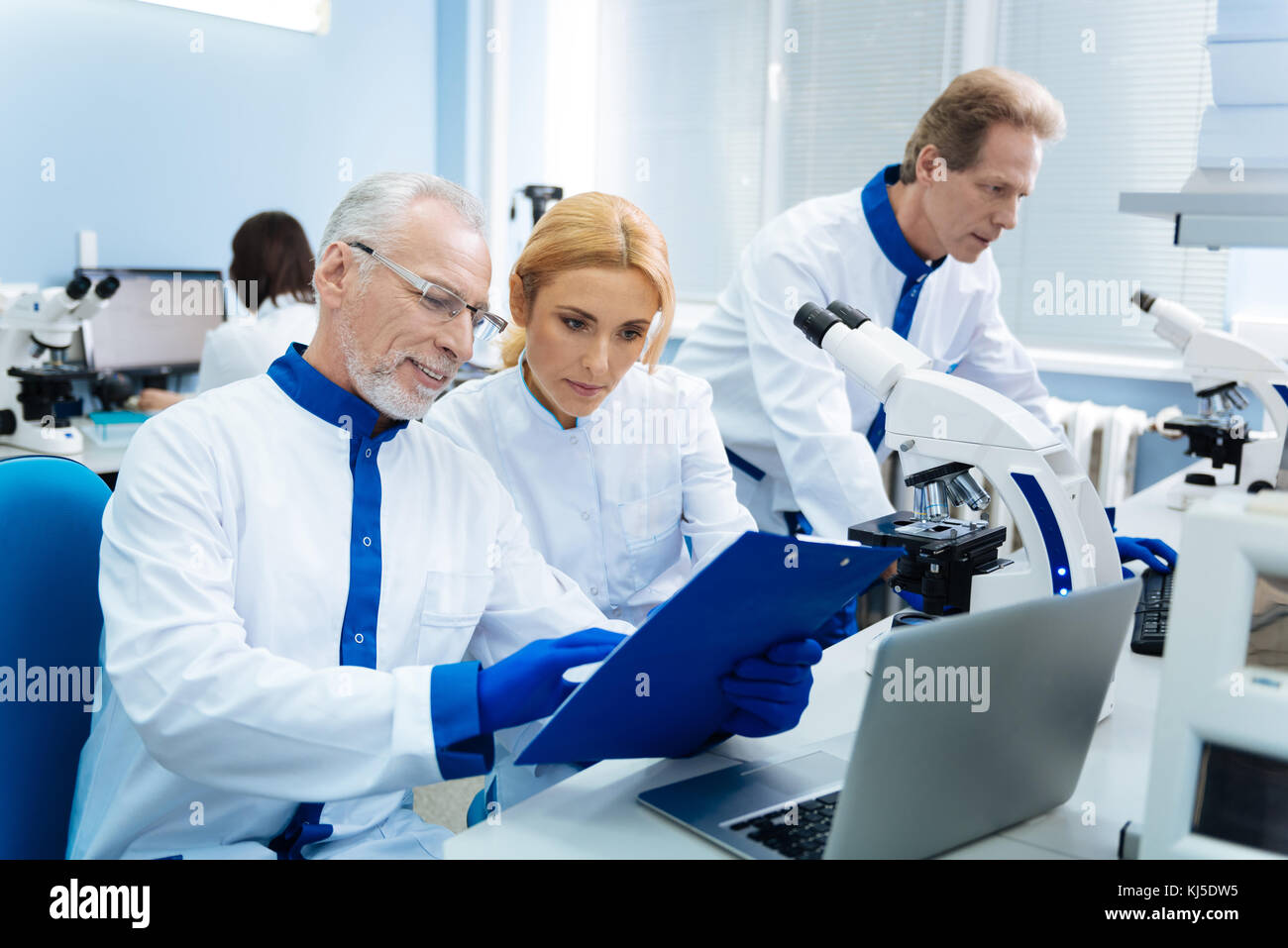 Glad scientists working in the laboratory Stock Photo - Alamy