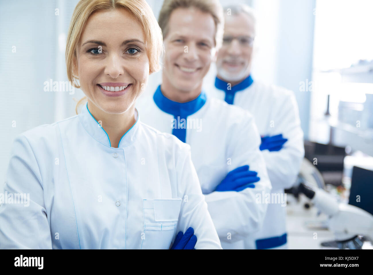 Inspired scientists standing together in lab Stock Photo - Alamy