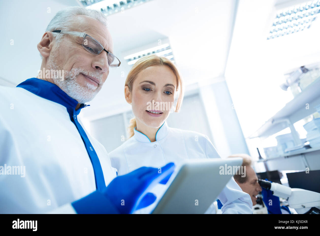 Satisfied researchers examining test results Stock Photo - Alamy