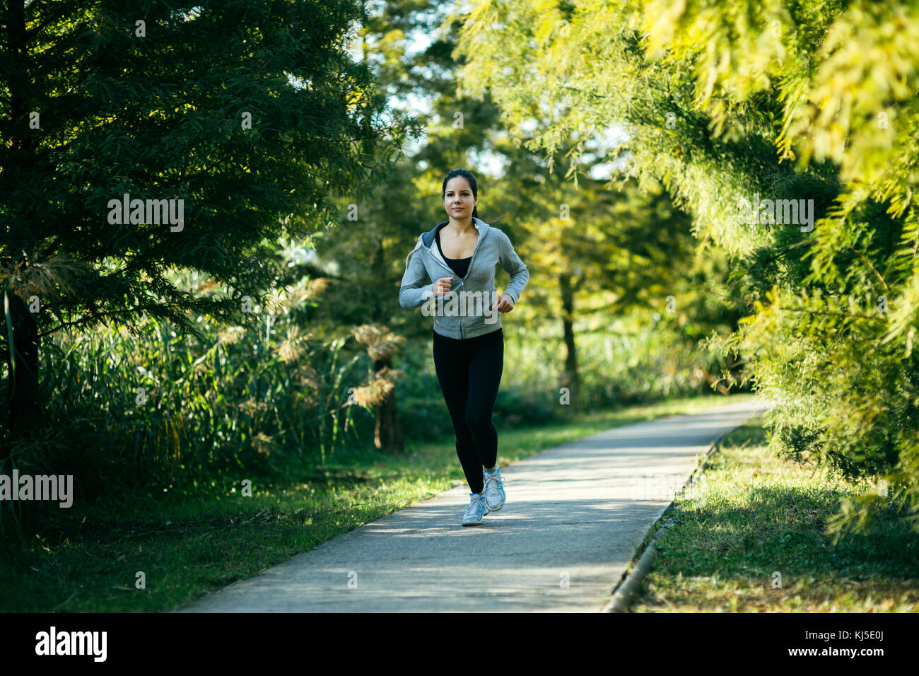 Fit woman jogging in nature Stock Photo - Alamy