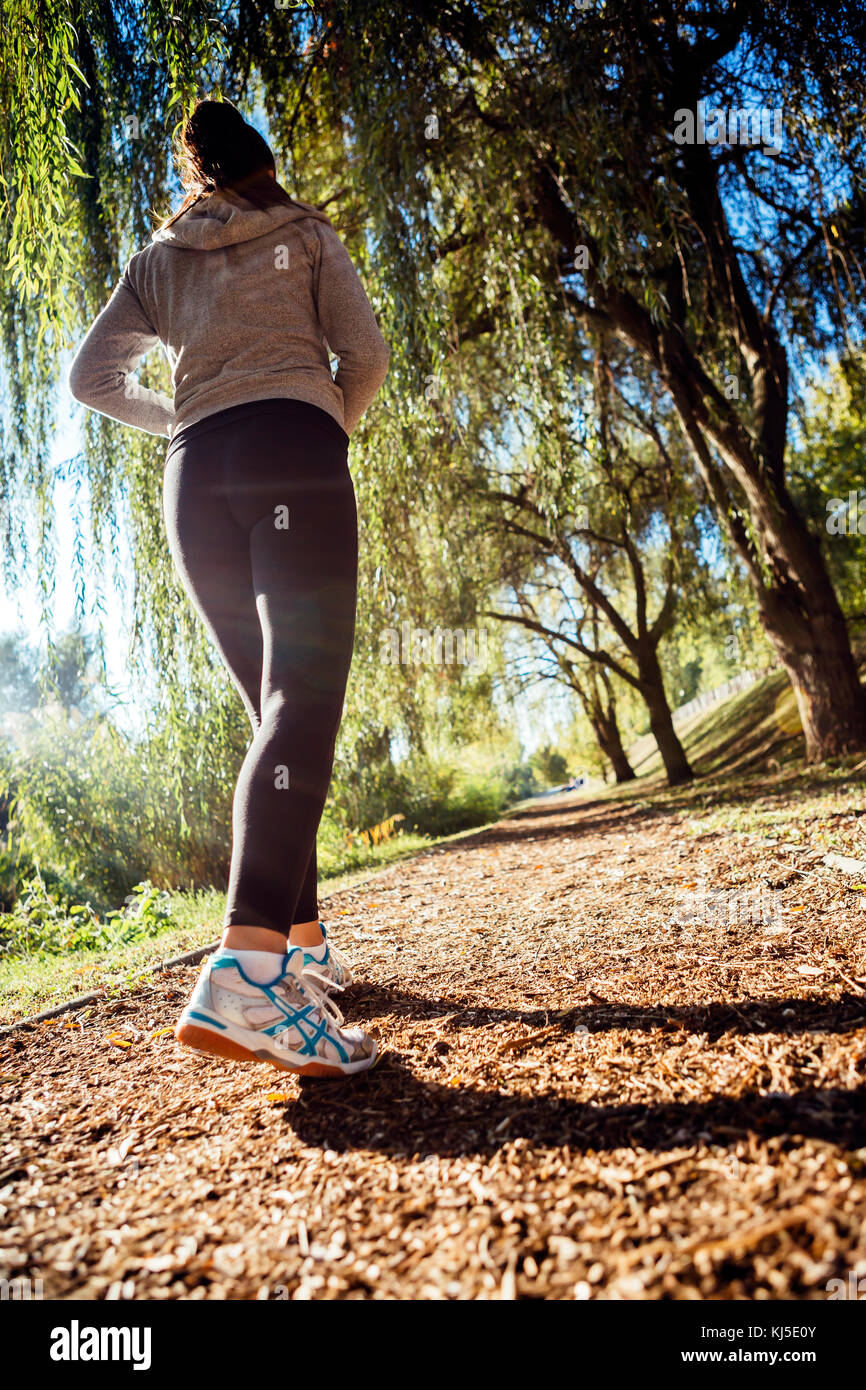 Fit beautiful woman jogging in park Stock Photo - Alamy