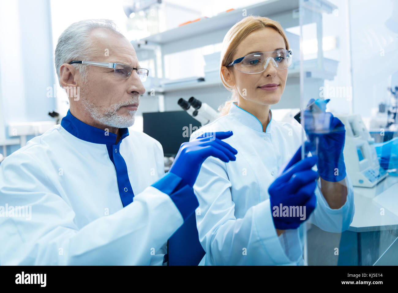Happy scientist working with glass Stock Photo - Alamy