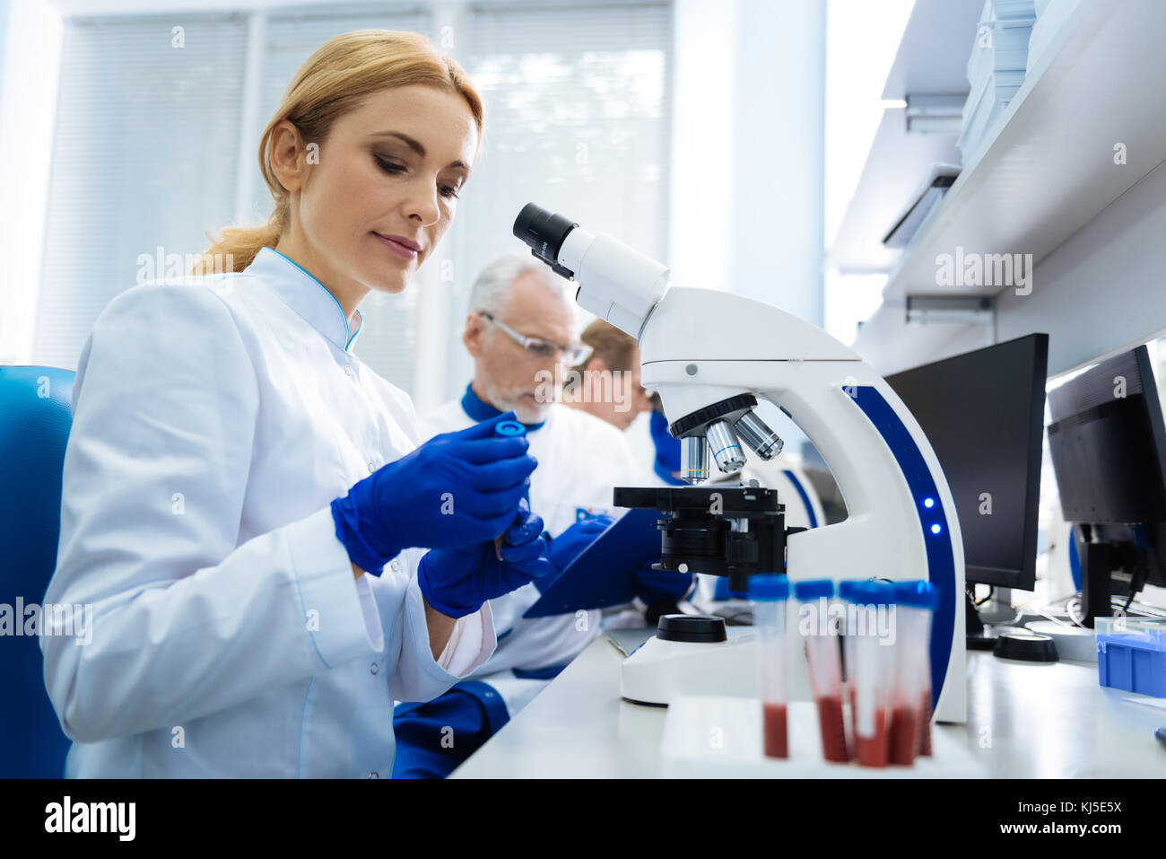 Serious scientist working with test tubes Stock Photo - Alamy