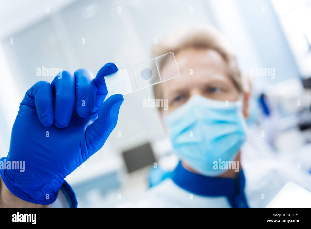 Determined scientist observing his scientific sample Stock Photo - Alamy