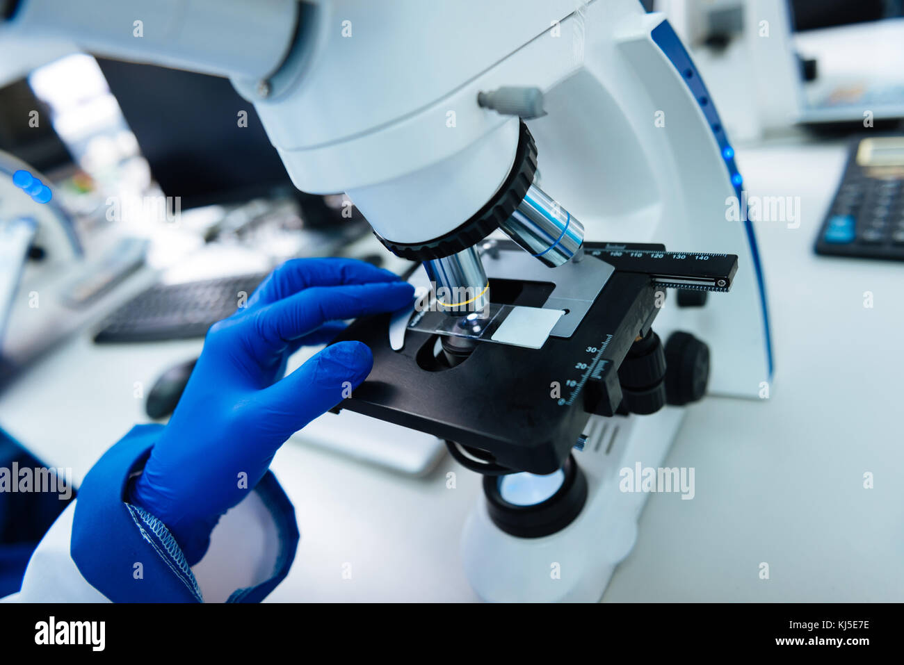 Researcher conducting his research using a microscope Stock Photo - Alamy