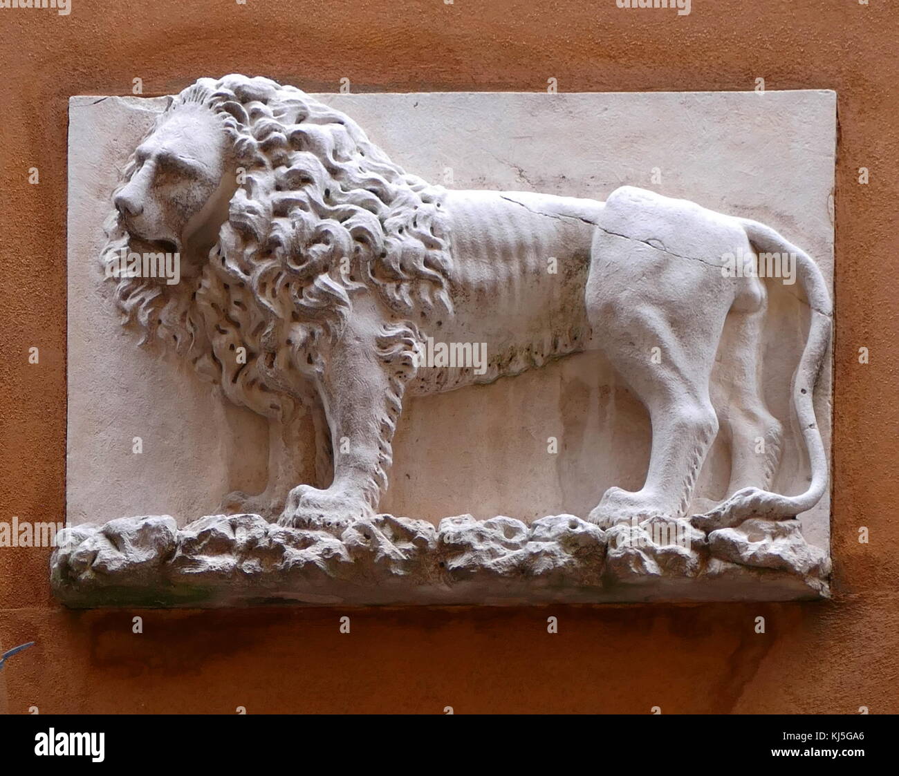The Lion symbol of Venice, depicted on a wall relief, in the city Stock ...