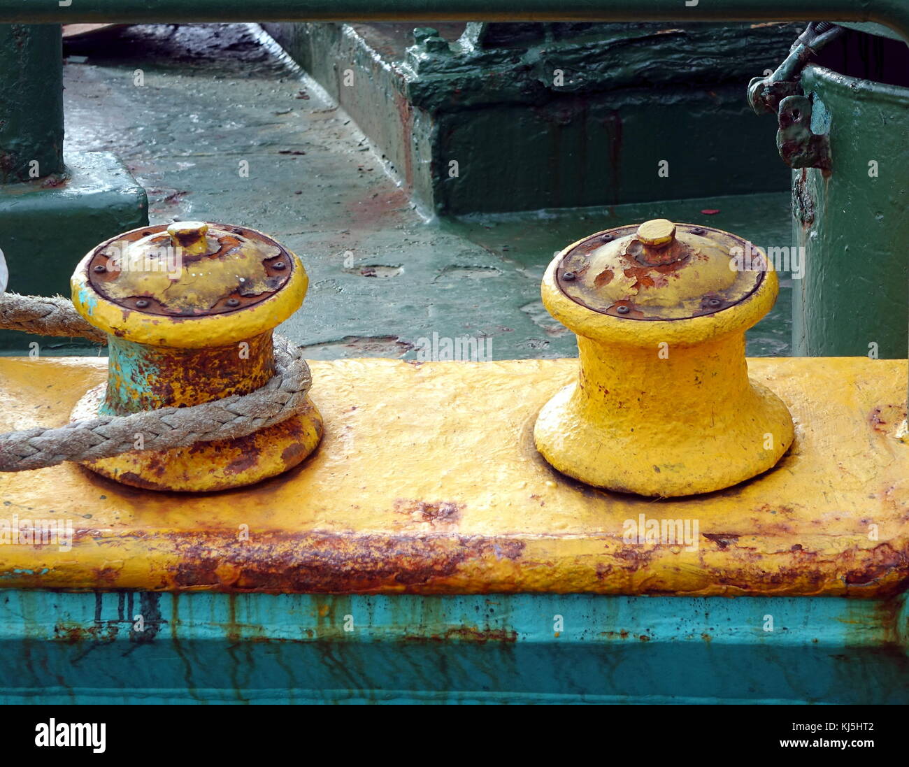 Two old mooring posts with a thick rope wrapped around it Stock Photo ...