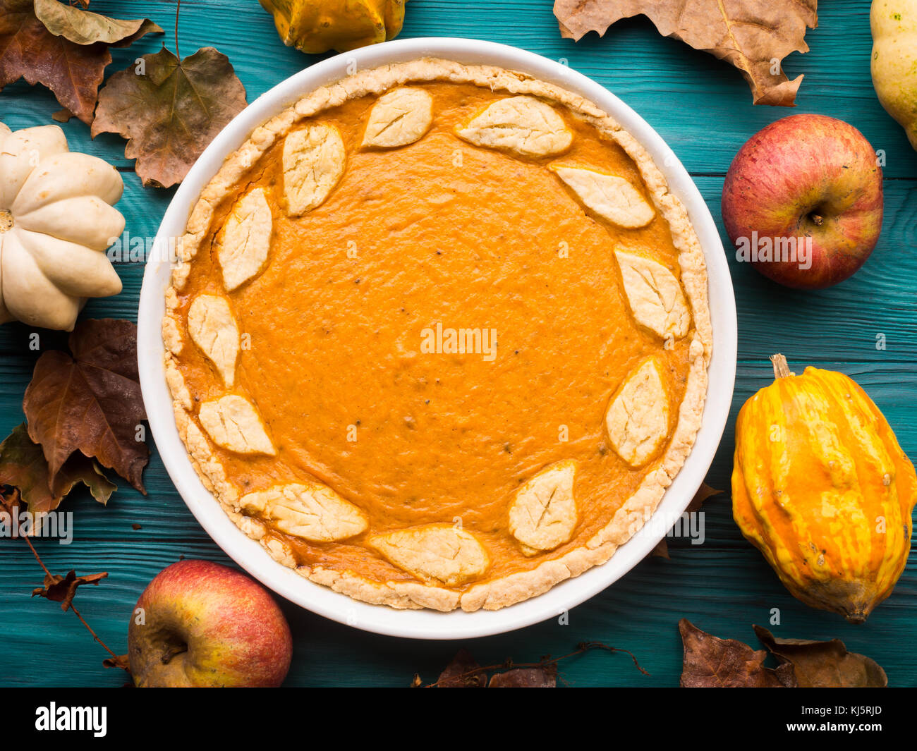 Autumn fall still life background on dark green wooden table. Pumpkins ...